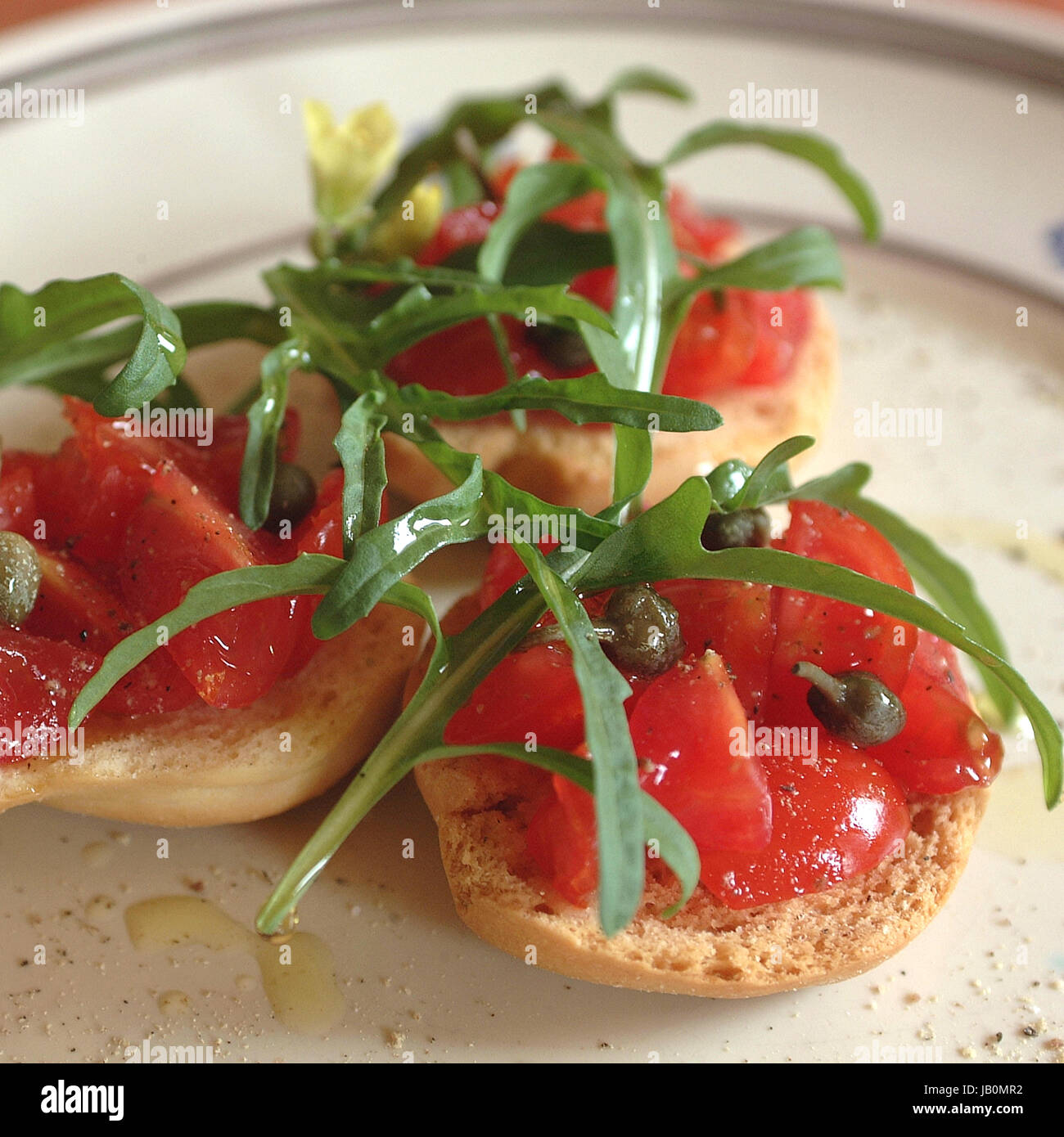 Frisella with tomato, rocket and capers Stock Photo - Alamy