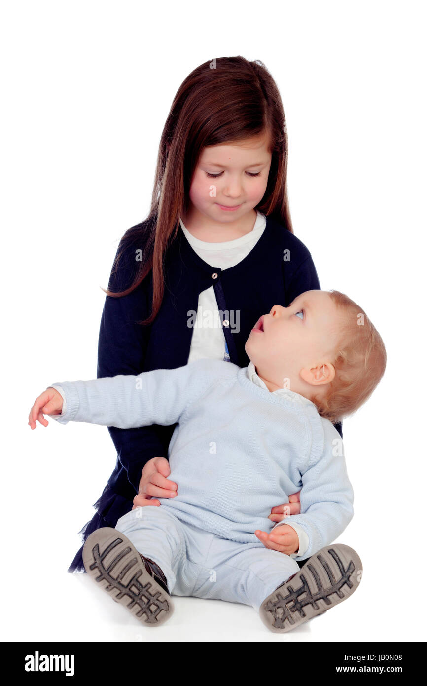 Loving girl taking care of her little brother isolated on a white ...