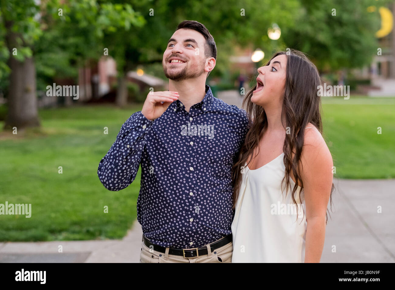 Two college students being funny for the camera during their graduation ...