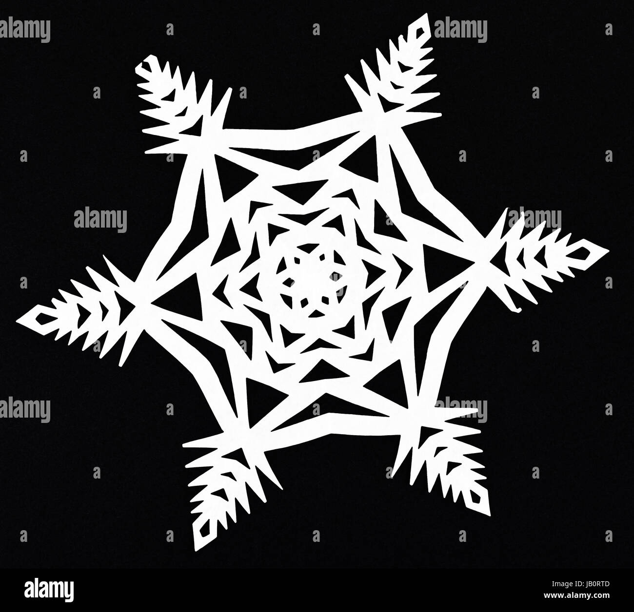 hand made cut out white snowflake on black paper background Stock Photo ...