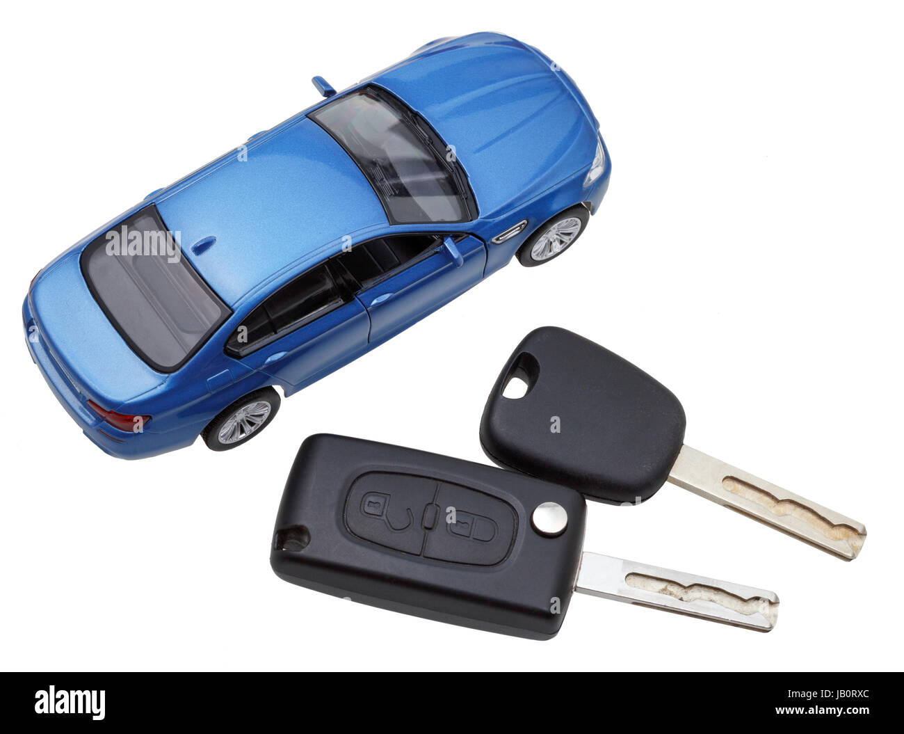 above view of two vehicle keys and model car isolated on white ...