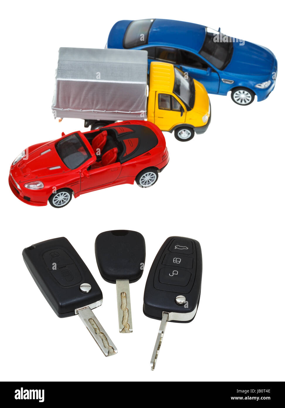 top view of three vehicle keys and model cars isolated on white ...