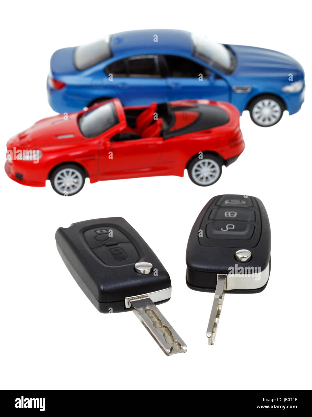 two vehicle keys close up and model cars isolated on white background ...