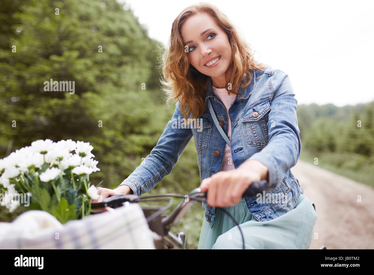 Happy cyclist riding in forest Stock Photo - Alamy