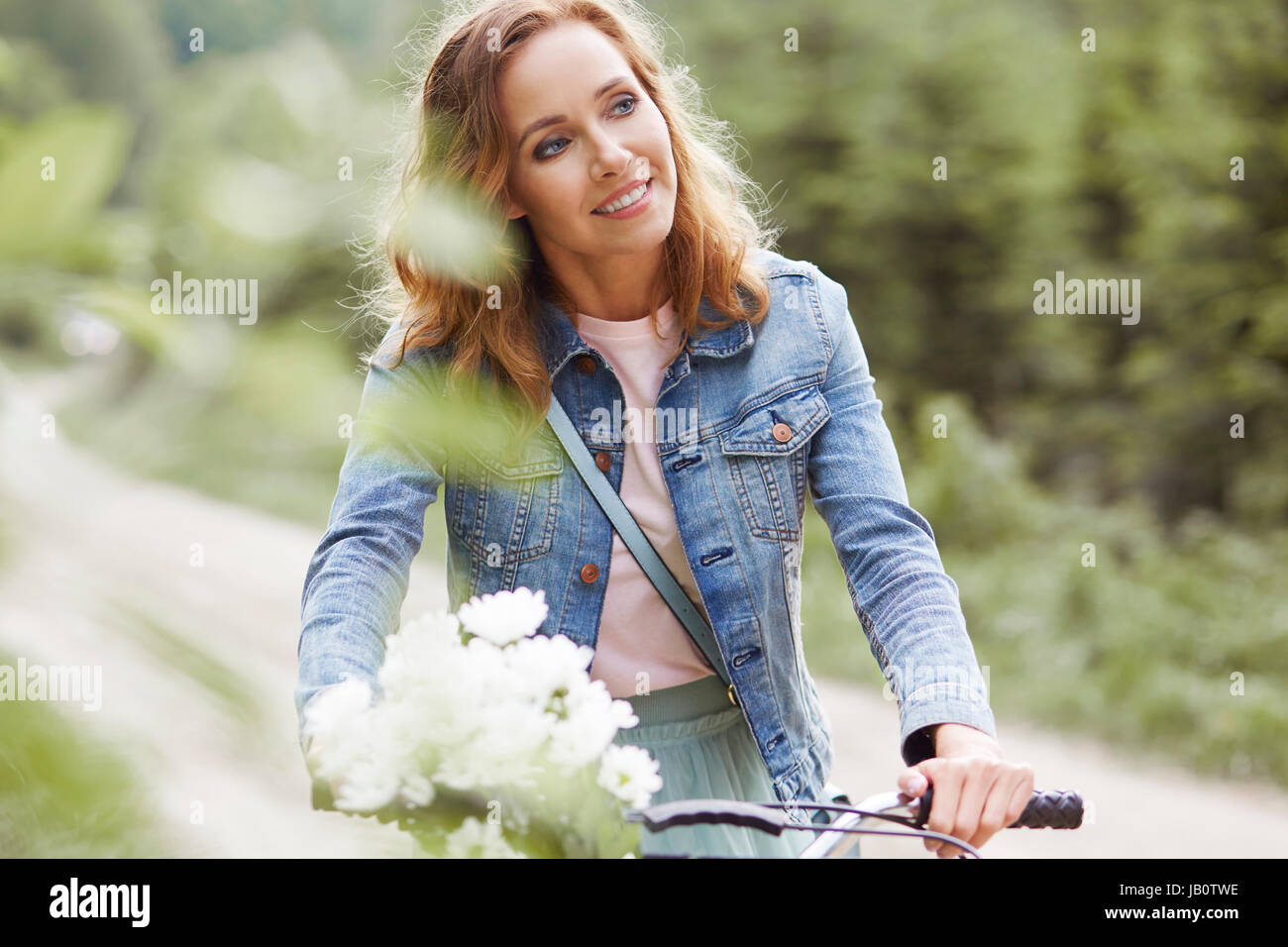 Beautiful woman riding a bike Stock Photo - Alamy