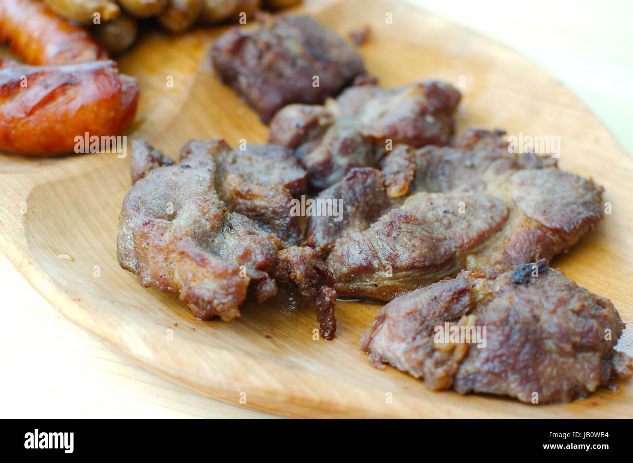 Gypsy Roast Pieces on a Wooden Plate Stock Photo - Alamy