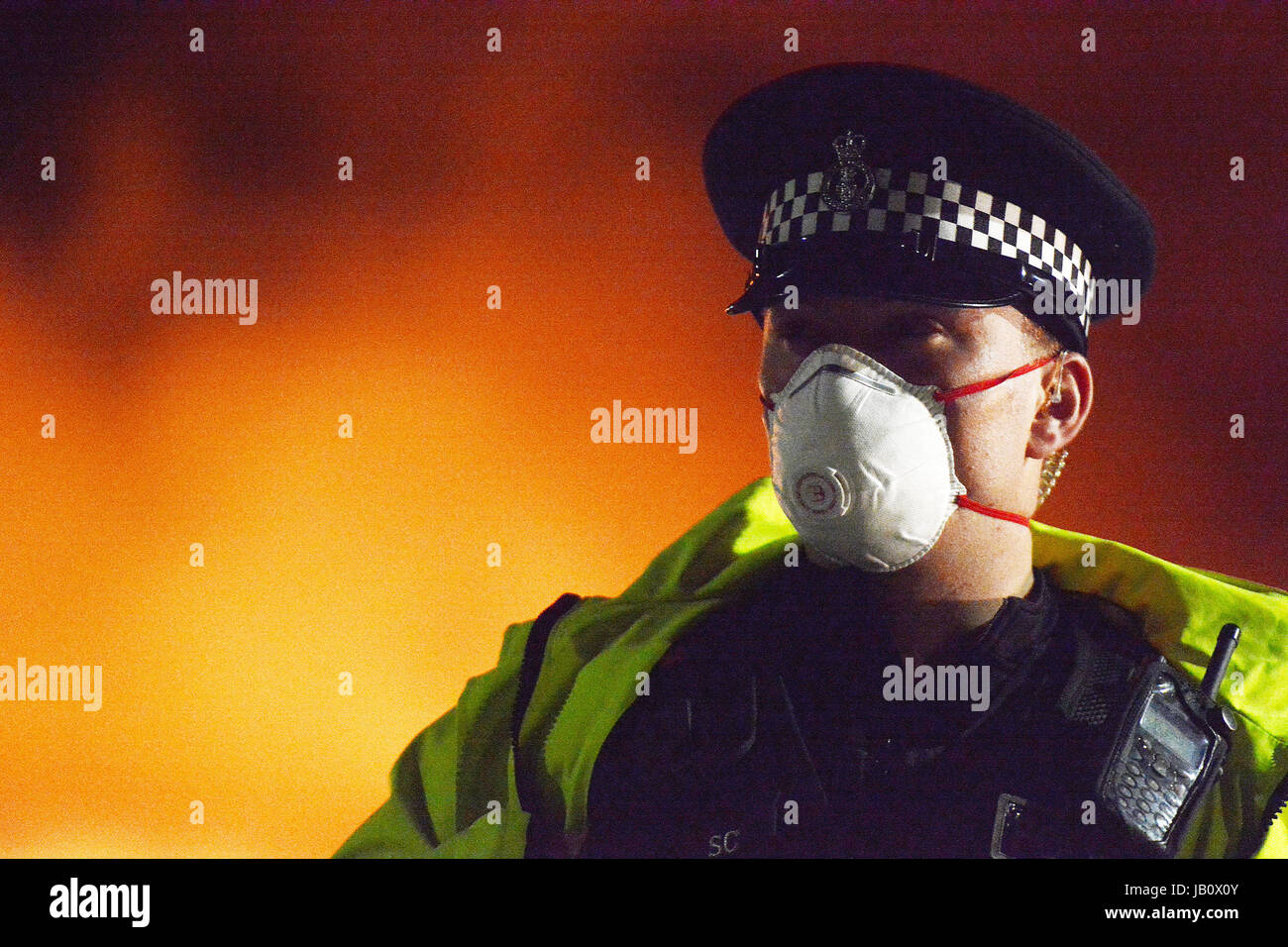 A Police Officer at the scene of a fire wearing a protective mask Stock ...