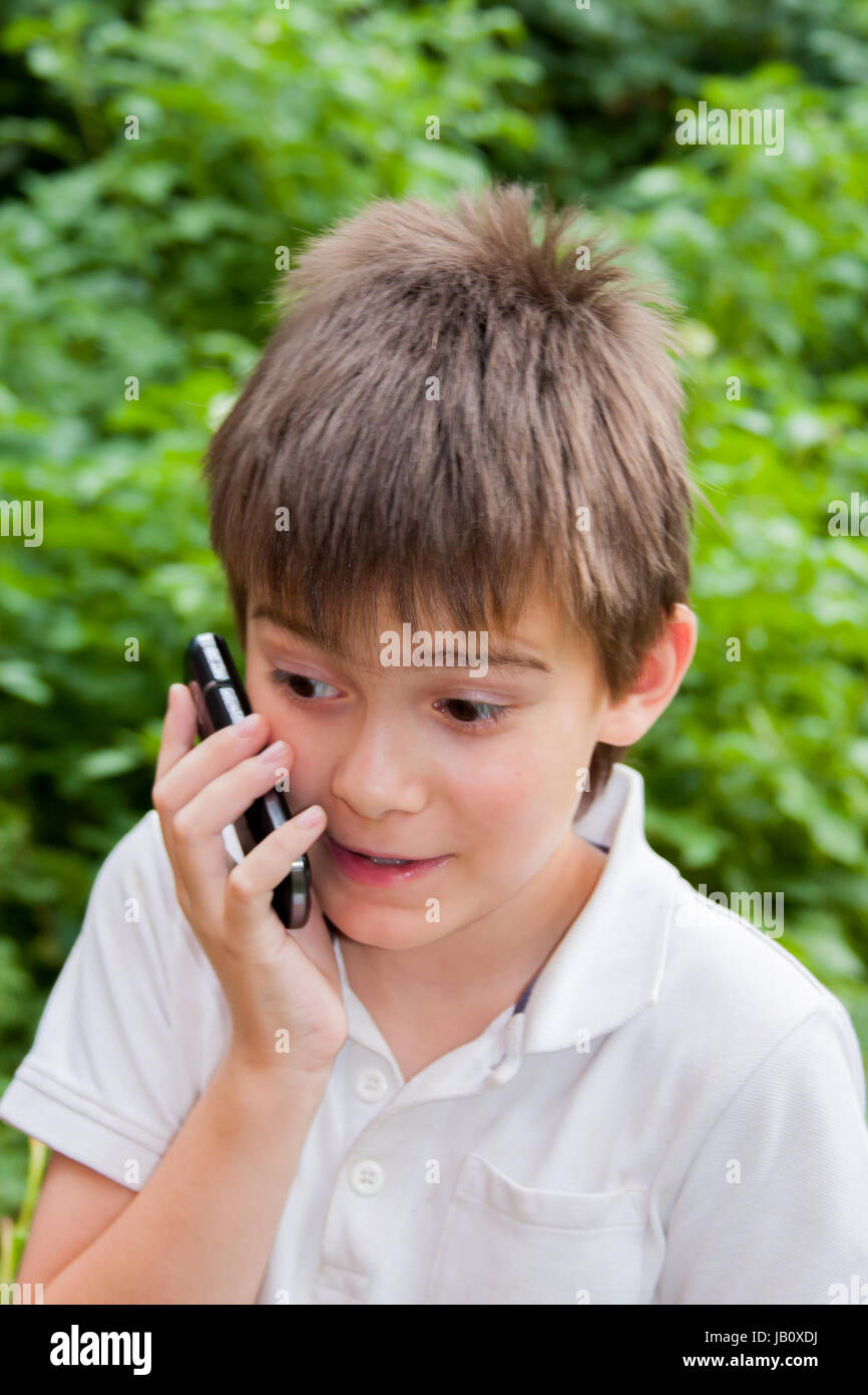 Schoolboy talking on phone green hi-res stock photography and images ...