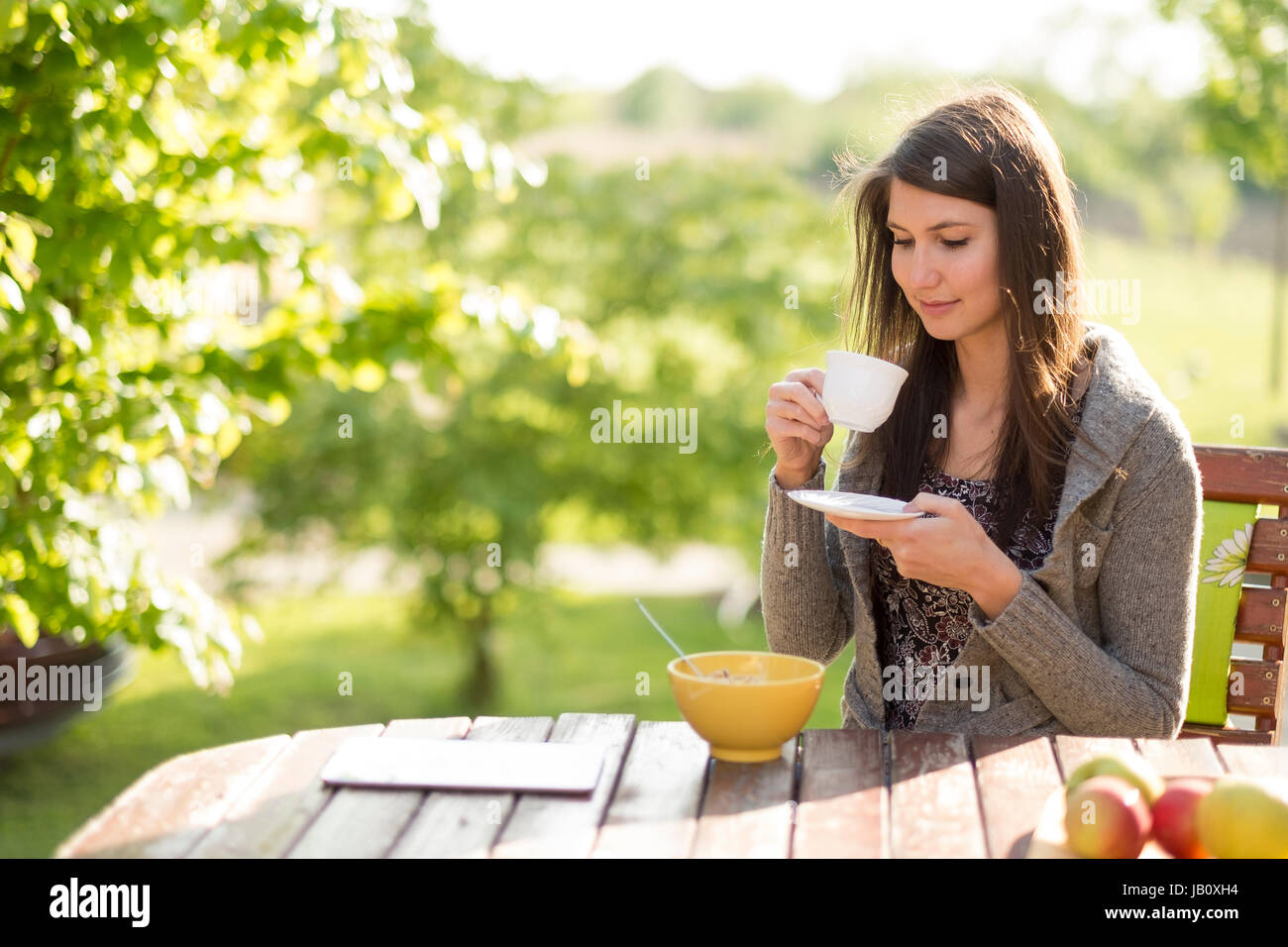 Woman with morning coffee outdoors Stock Photo - Alamy