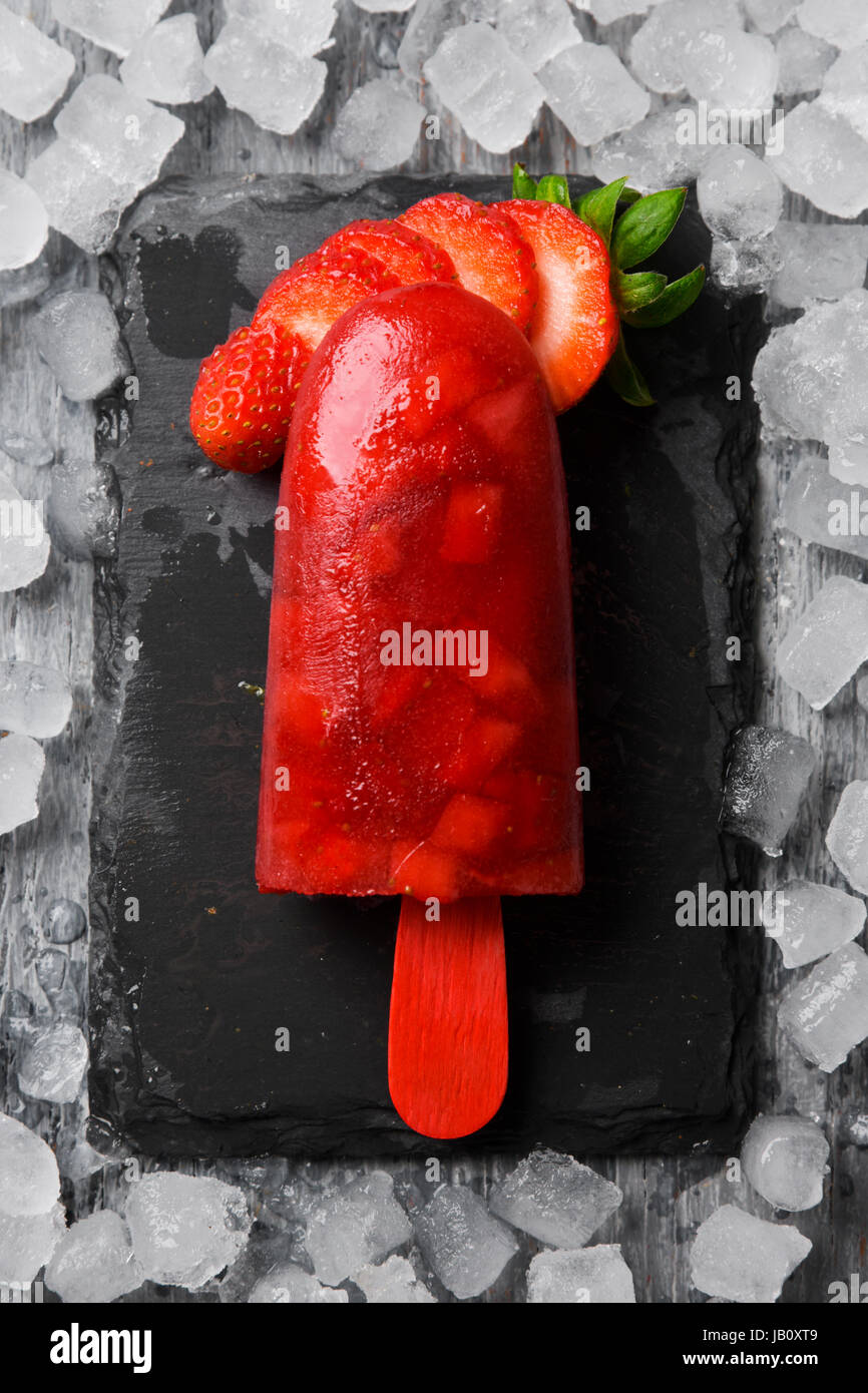 high-angle shot of a homemade ice pop made with natural strawberries ...