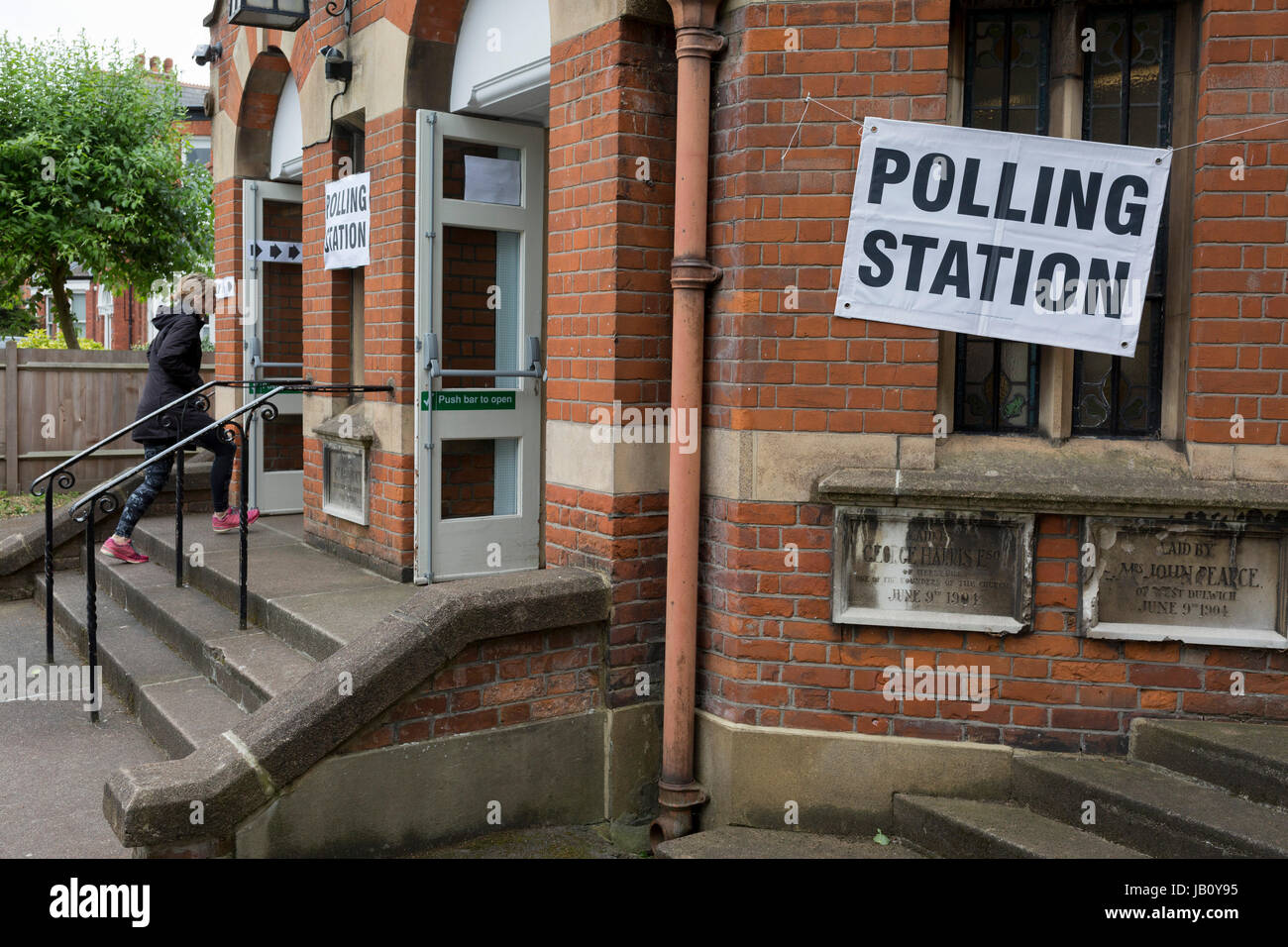 A voter enters a polling station on the morning of the UK's 2017 ...