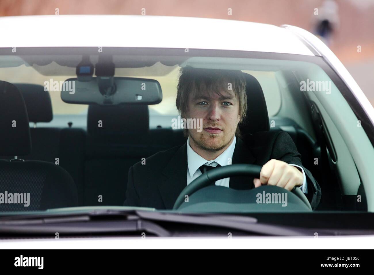 Man in suit driving a car Stock Photo - Alamy