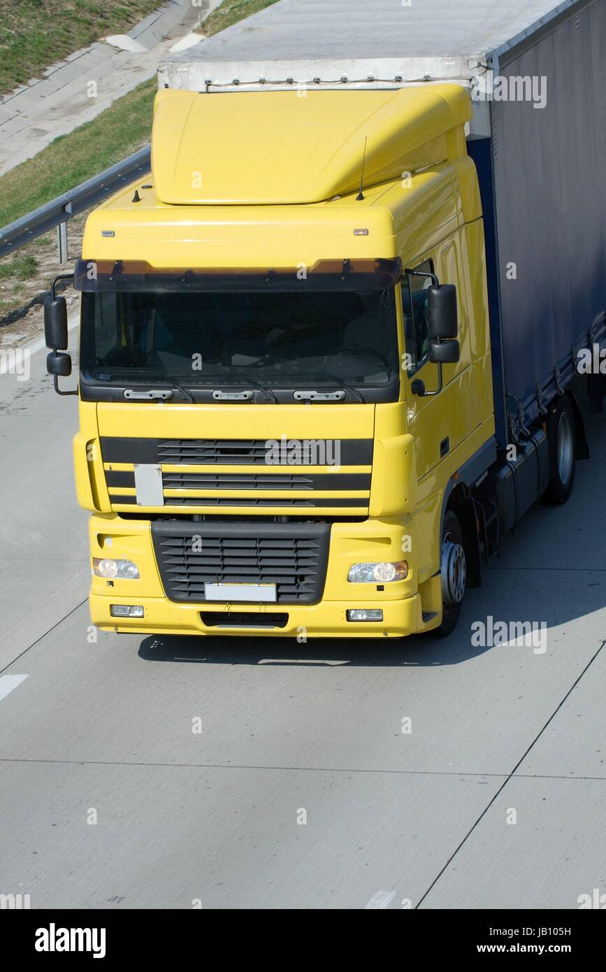Yellow trucks roaring on the highway Stock Photo - Alamy