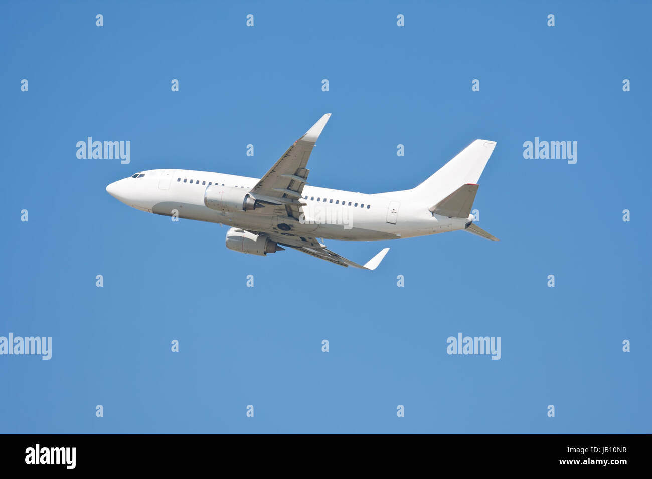 Beautiful white passenger airplane in blue sky Stock Photo - Alamy
