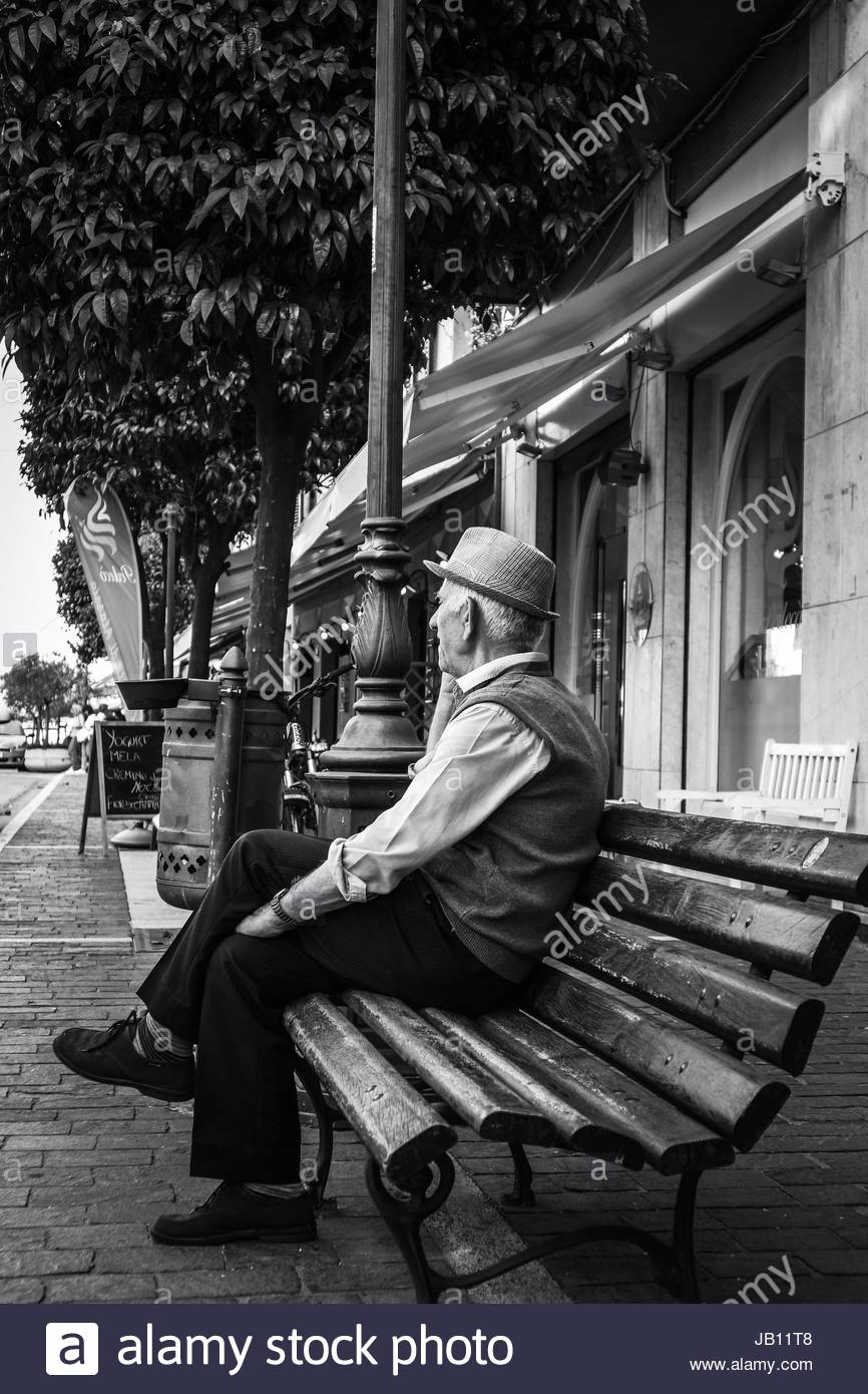 Old Man Sitting On A Bench Stock Photos & Old Man Sitting On A Bench ...