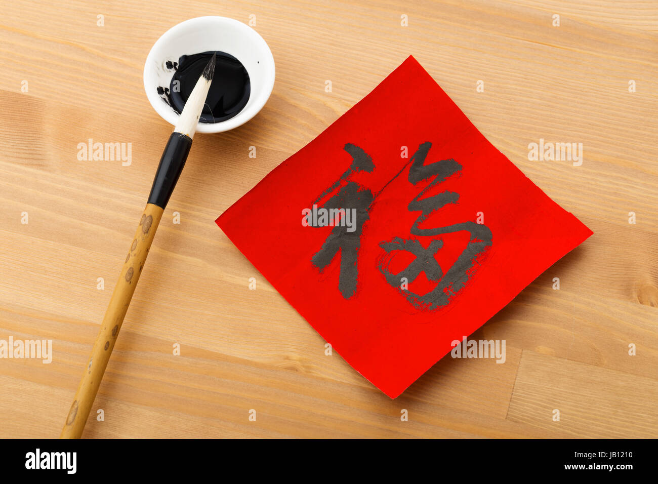 Writing Chinese calligraphy for Chinese new year, word Fu, mean good ...