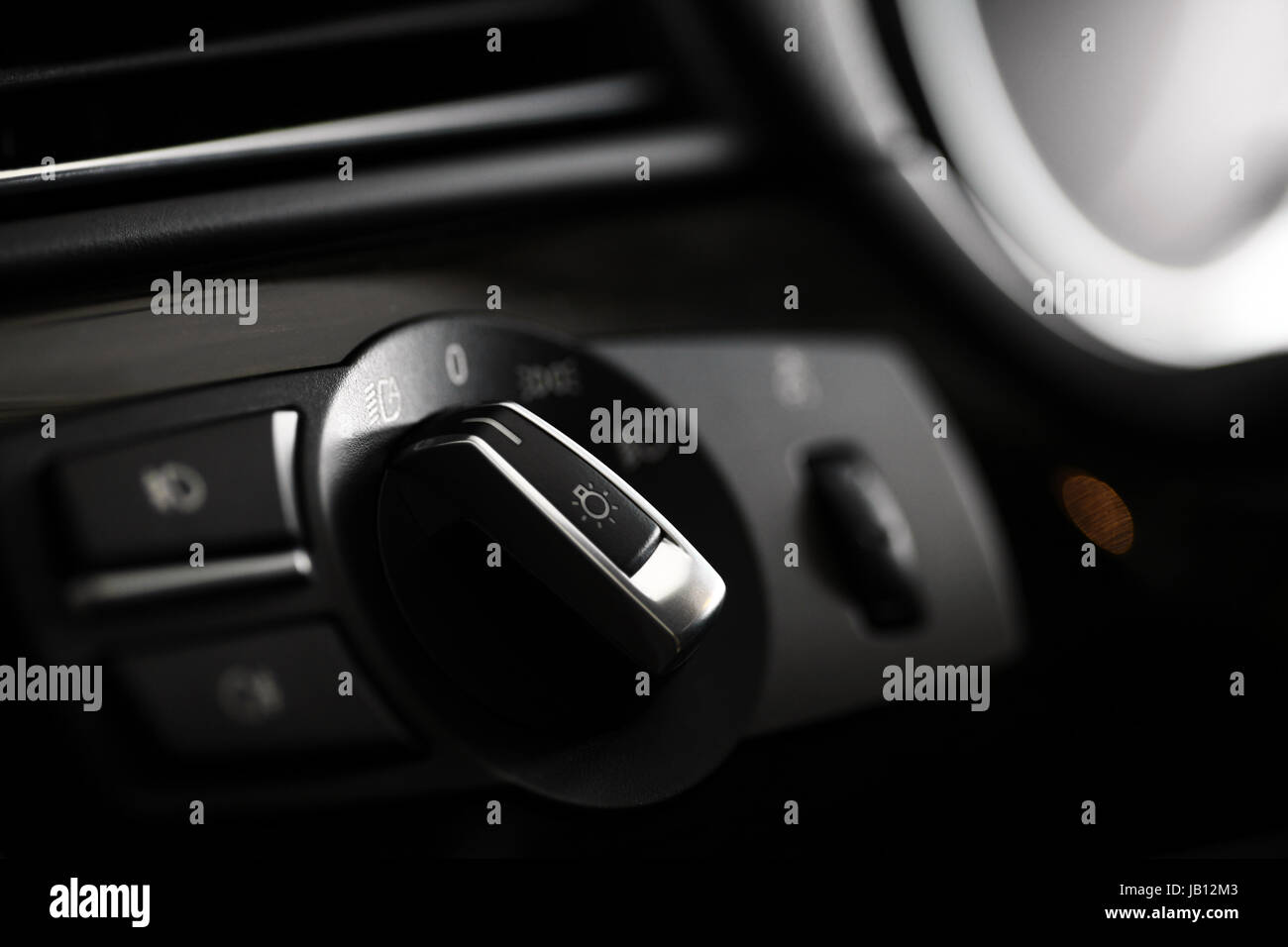 Detail of the headlight button in a car Stock Photo - Alamy