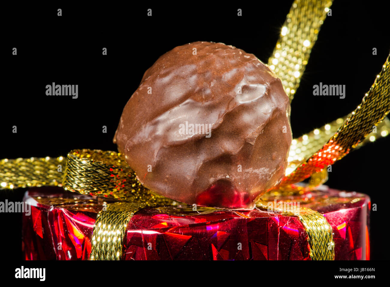 Chocolate bonbon and gold color shiny package Stock Photo - Alamy