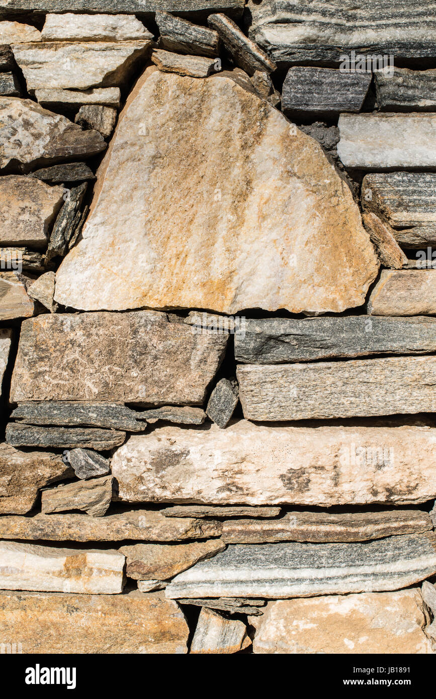 Wall built of stones. Densely arranged stones. Sun light Stock Photo ...