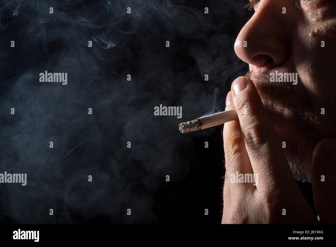 Portrait man smoking cigarette, closeup on black background Stock Photo ...