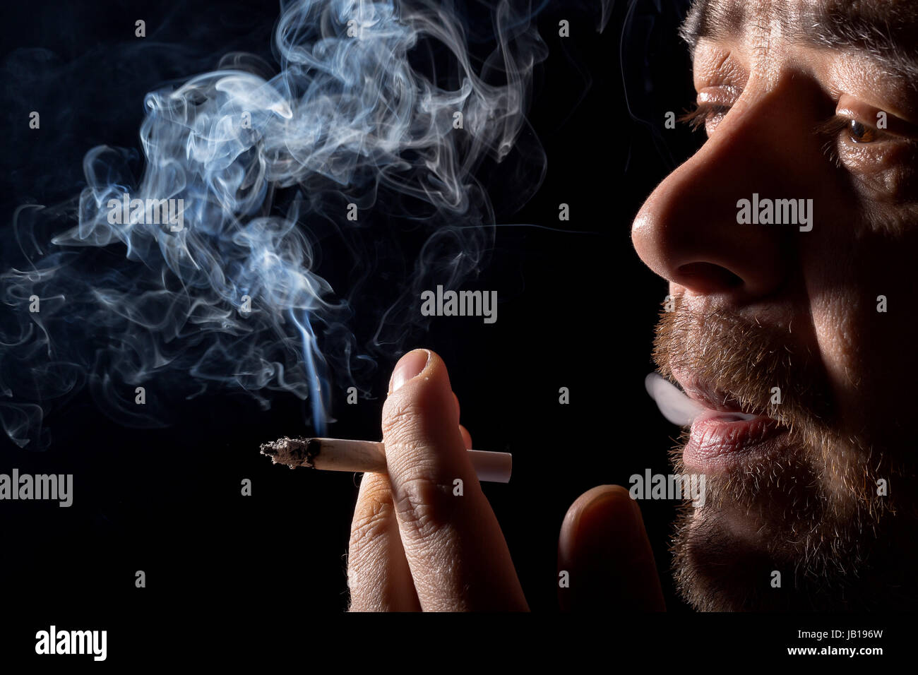 Portrait man smoking cigarette, closeup on black background Stock Photo ...