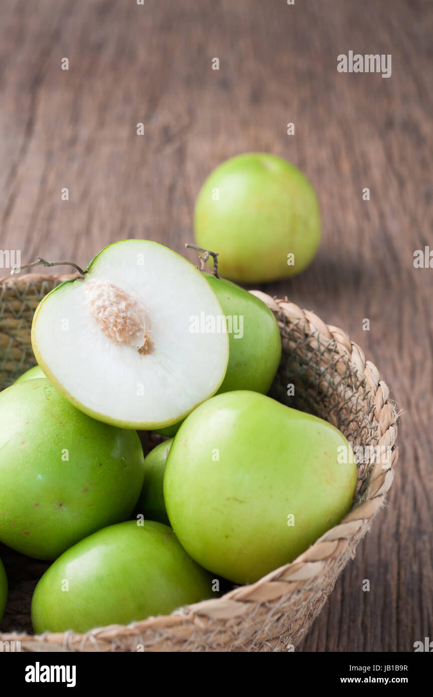kitchen table with slice fresh monkey apple on basket. healthy eating ...