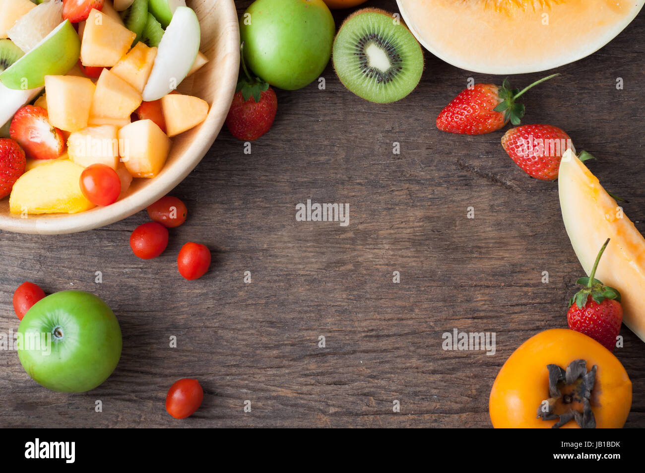 kitchen table with Variety of Fruits frame, Fruits salad on wood plate ...