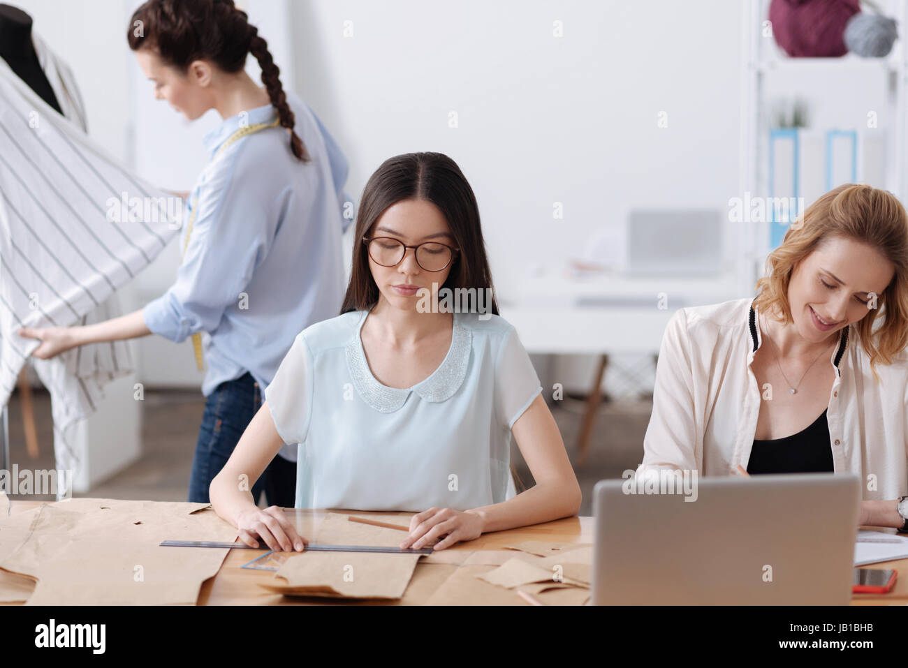 Three women working at the atelier Stock Photo - Alamy