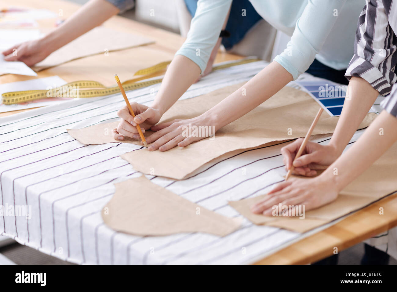 Two pairs of female hands tracing patterns Stock Photo - Alamy
