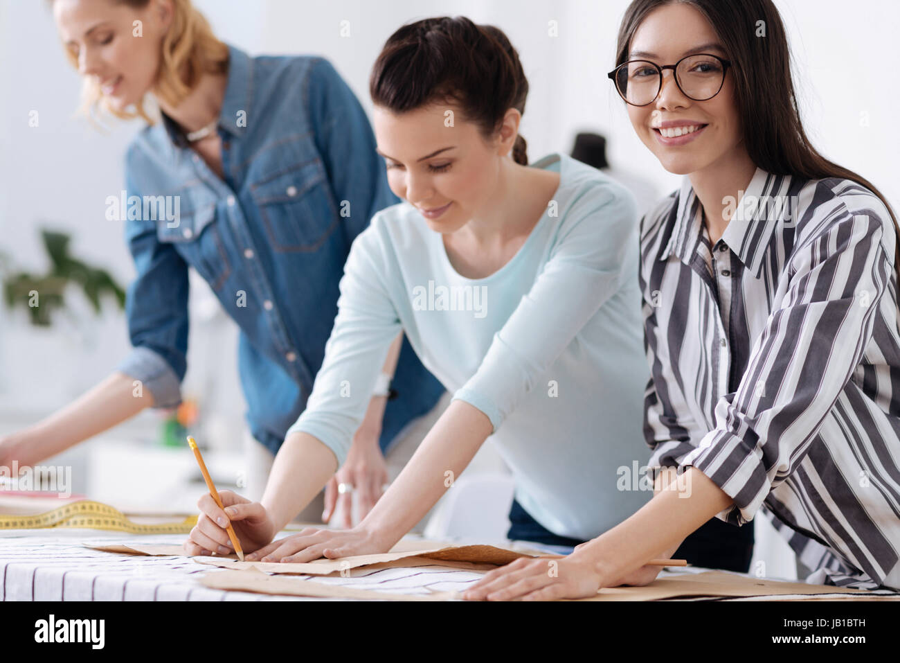 Beautiful smiling women tracing patterns Stock Photo - Alamy