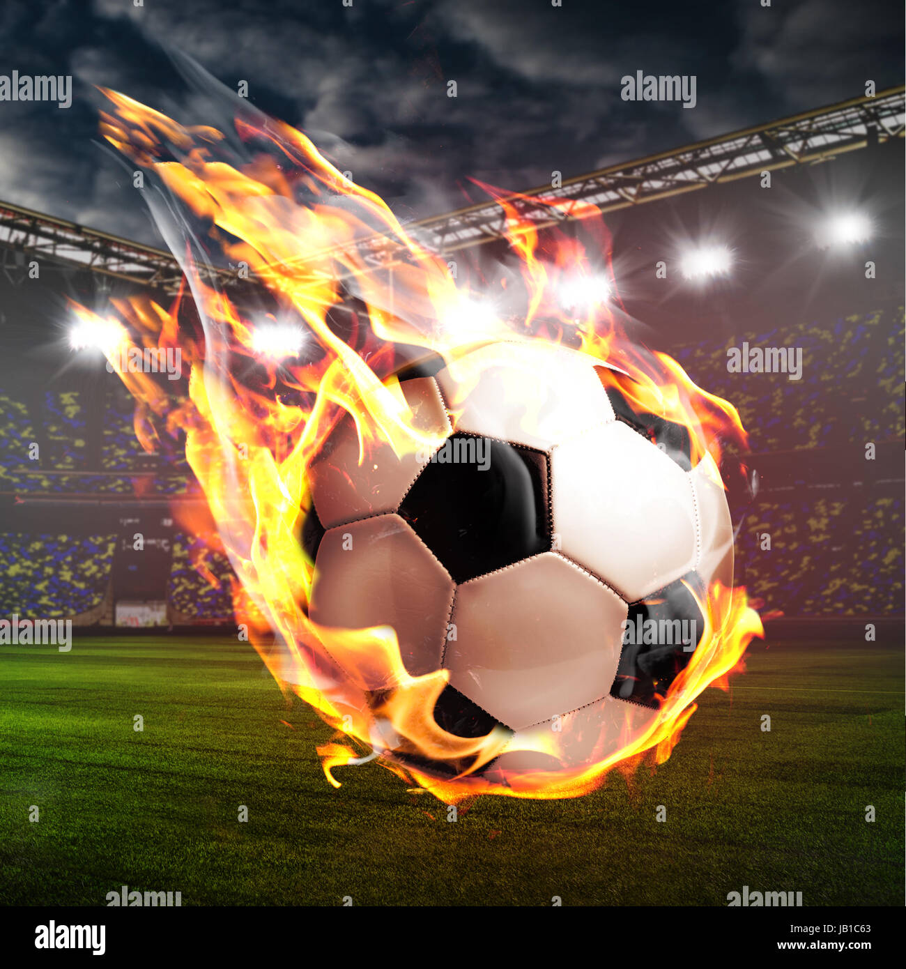 Burning soccer ball on stadium Stock Photo - Alamy