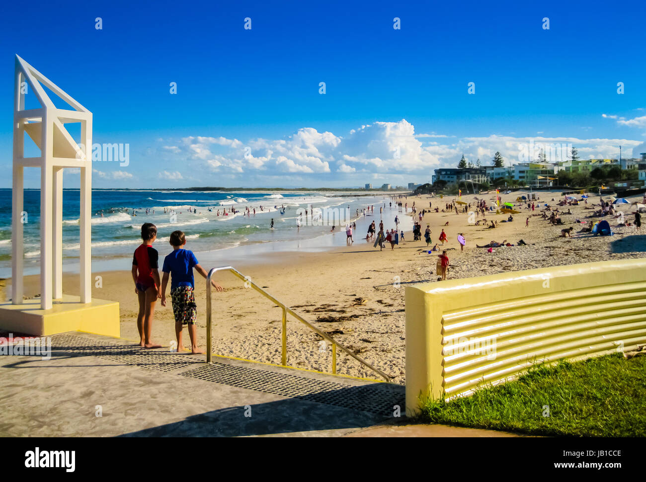 Two boys are watching the people enjoying the sunny day at the King's ...
