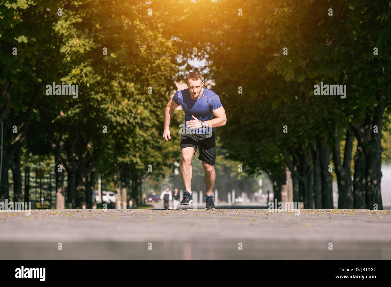 Man running in park at morning. Healthy lifestyle concept Stock Photo ...
