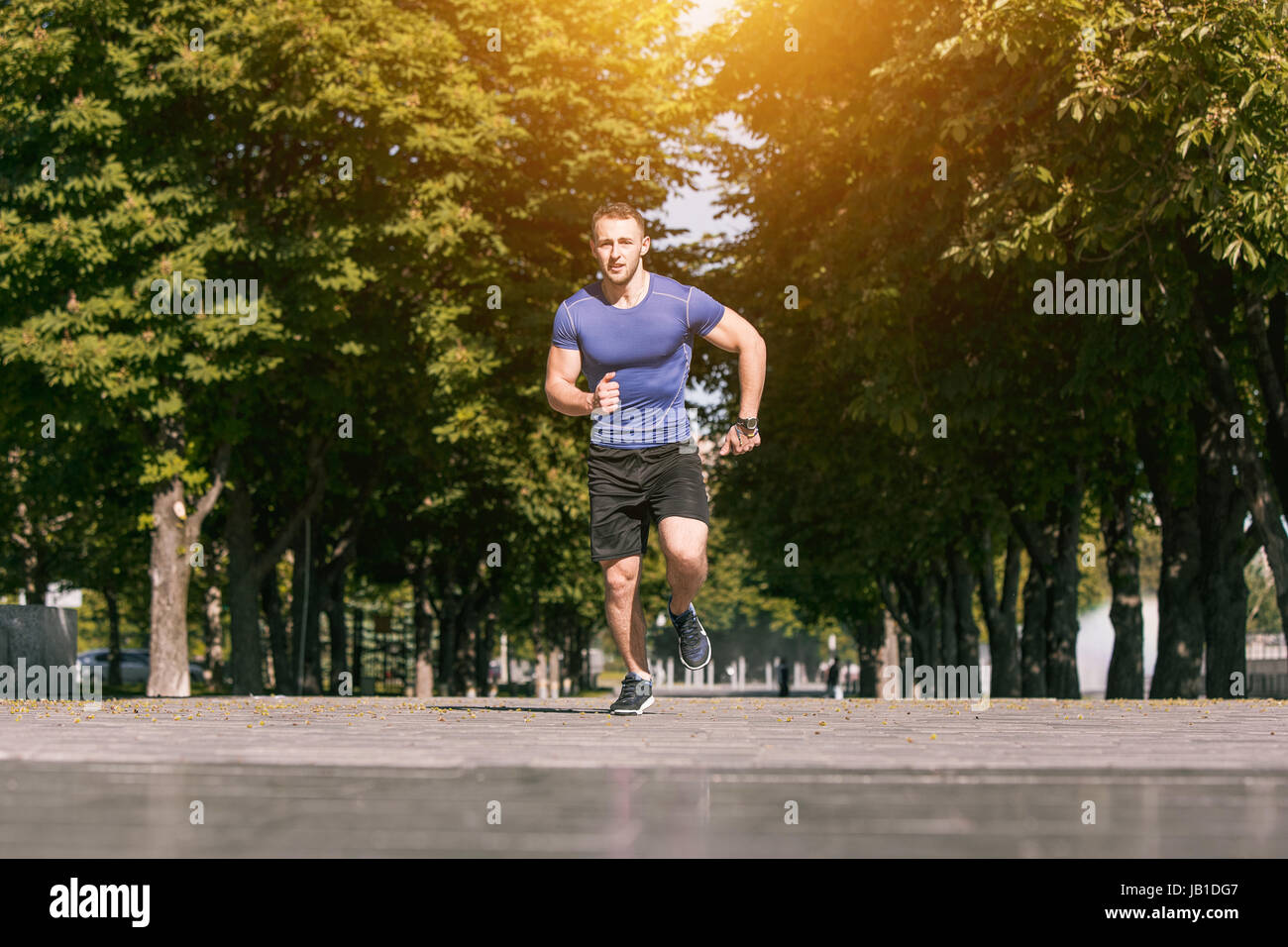 Man running in park at morning. Healthy lifestyle concept Stock Photo ...