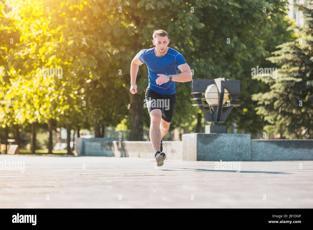 Man running in park at morning. Healthy lifestyle concept Stock Photo ...
