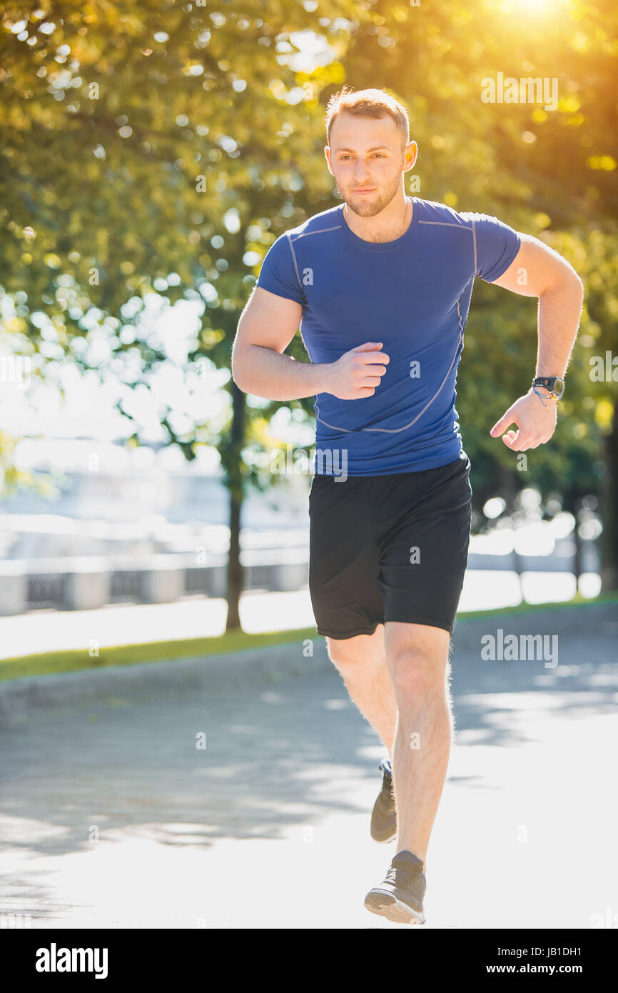 Man running in park at morning. Healthy lifestyle concept Stock Photo ...