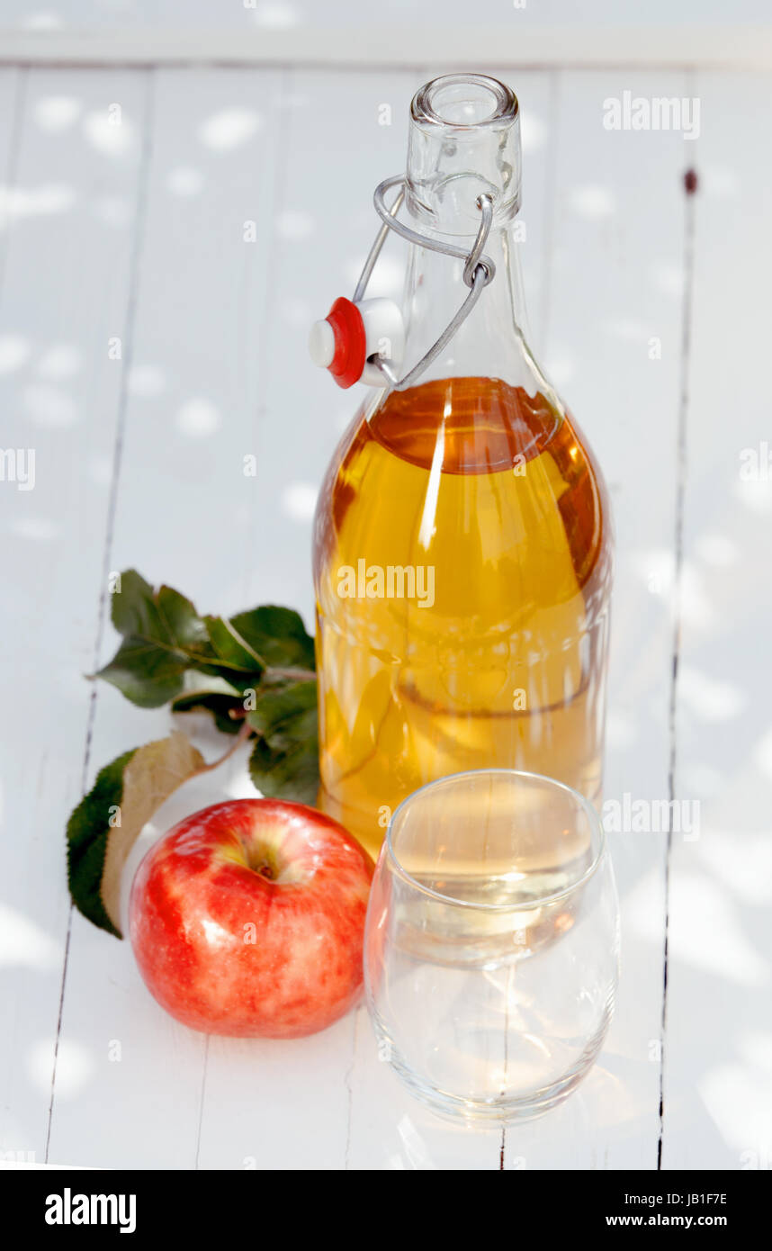 Bottle of healthy freshly squeezed apple juice with a delicious ripe ...