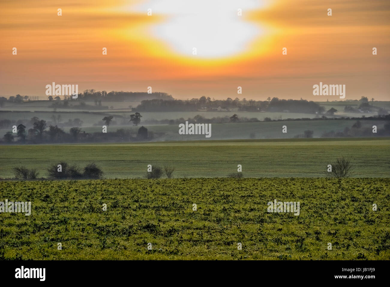Sunrise over farmland with early morning mist Stock Photo - Alamy