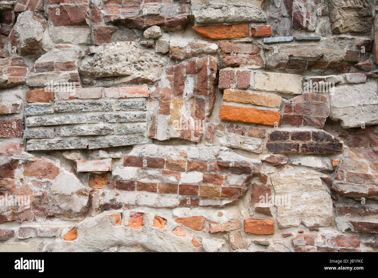 Stone wall made of a variety of rocks and bricks Stock Photo - Alamy