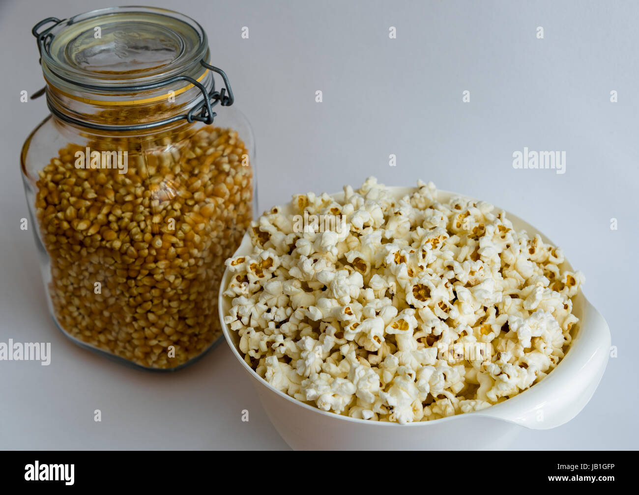 Homemade popcorn and corn seeds on white background Stock Photo - Alamy