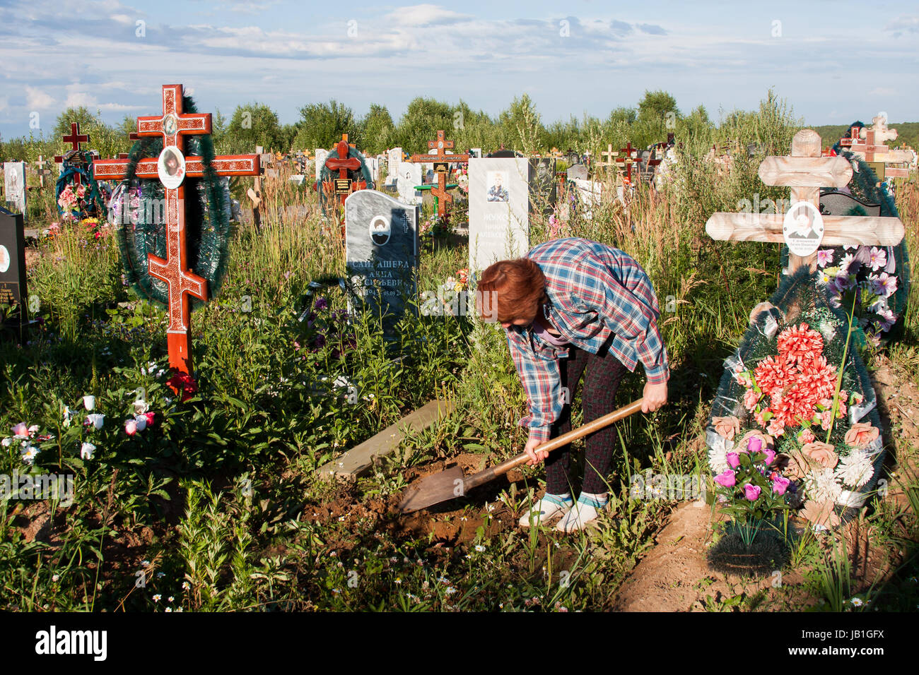 Elderly woman flowers grave hi-res stock photography and images - Alamy