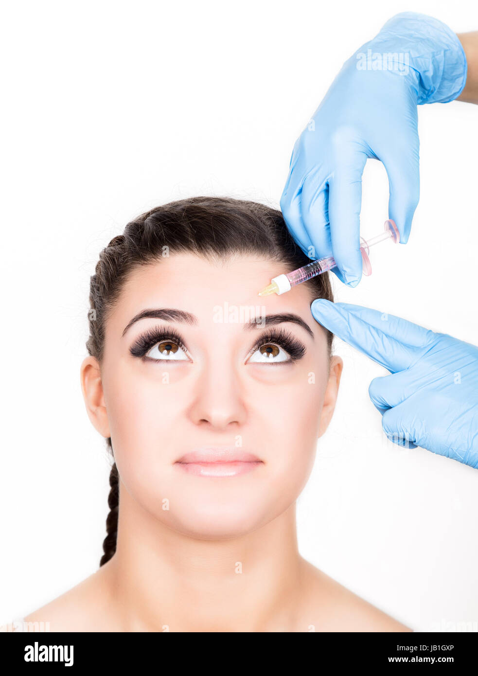 Beauty injection by doctor in blue gloves. Young woman in beauty salon ...