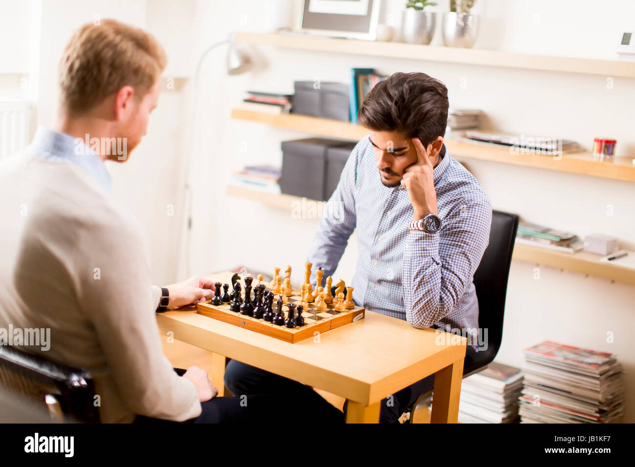 Portrait of a happy men playing chess at homme Stock Photo - Alamy