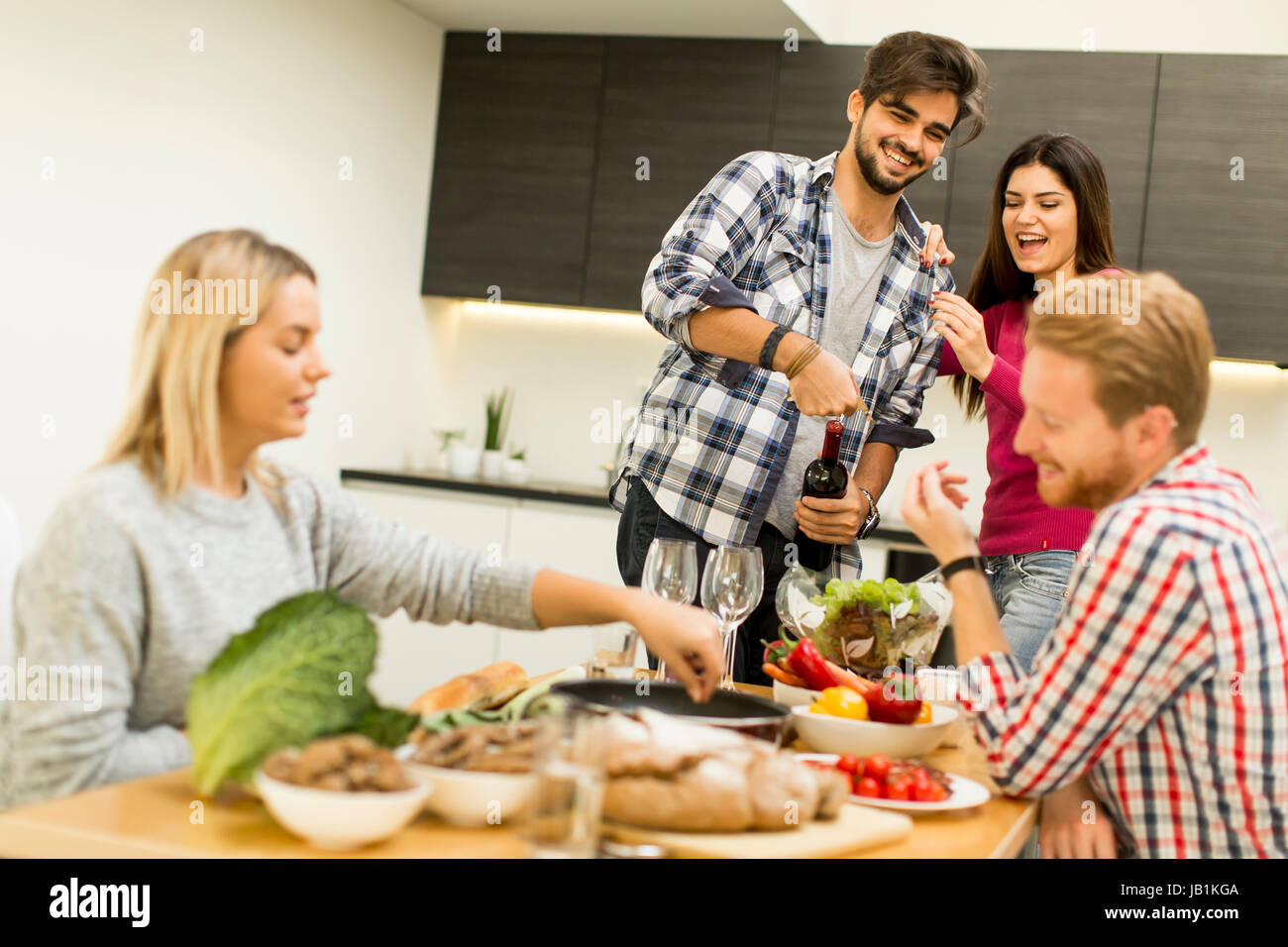 View at young people have a meal in the dining room in modern home ...