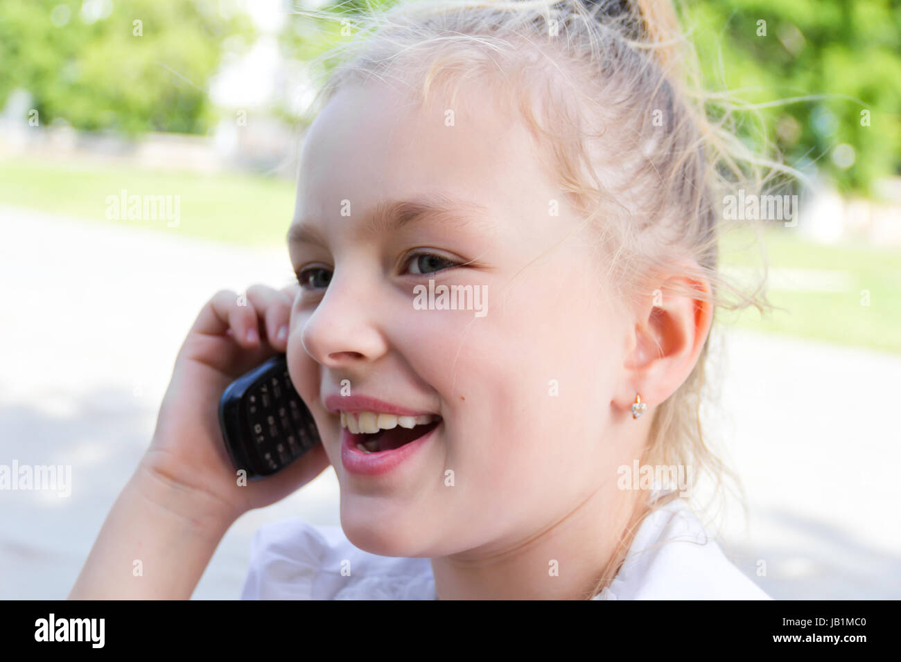 Photo of cute girl talking by cellular Stock Photo - Alamy