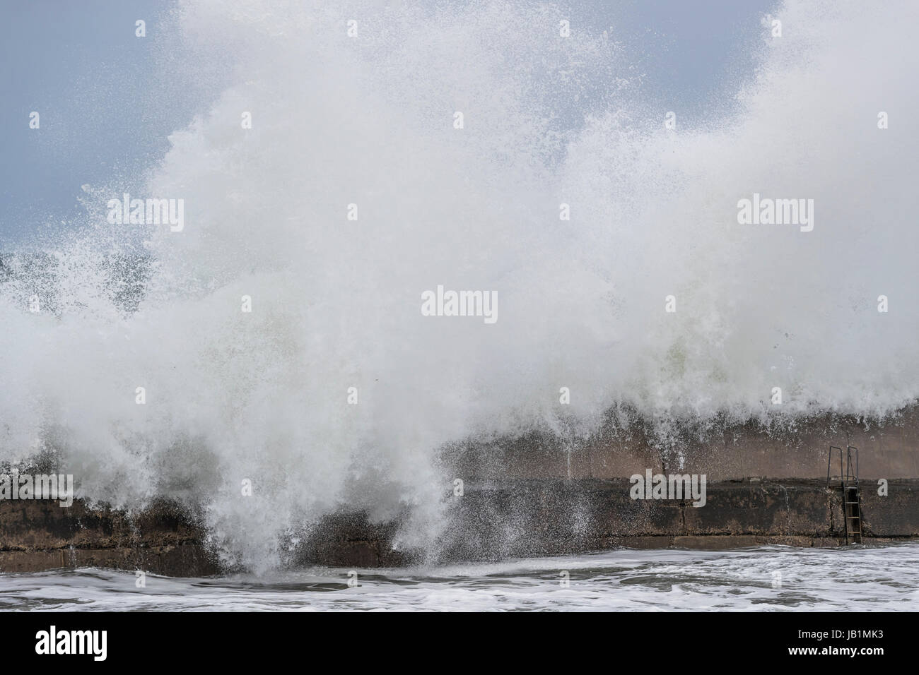 Storm waves crash over the harbour wall, Seahouses, Northumberland UK Stock Photo - Alamy