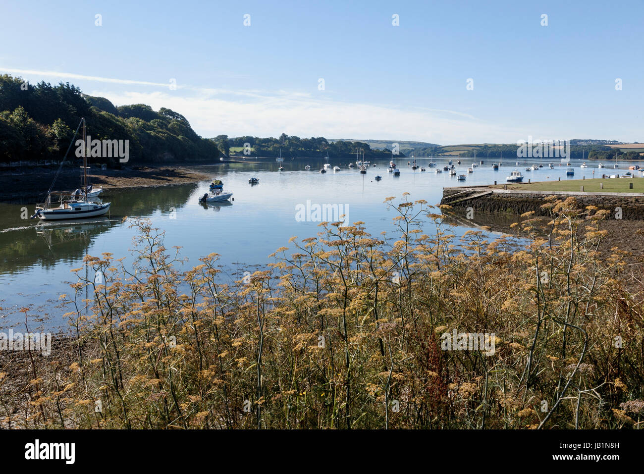 Kingsbridge Estuary in South Devon, UK. Boats reflected in calm water ...