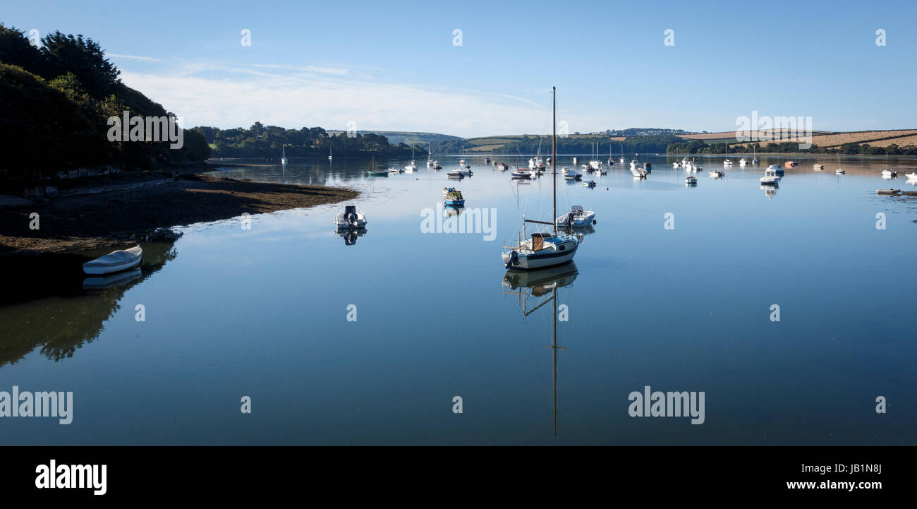 Kingsbridge Estuary in South Devon, UK. Boats reflected in calm water ...