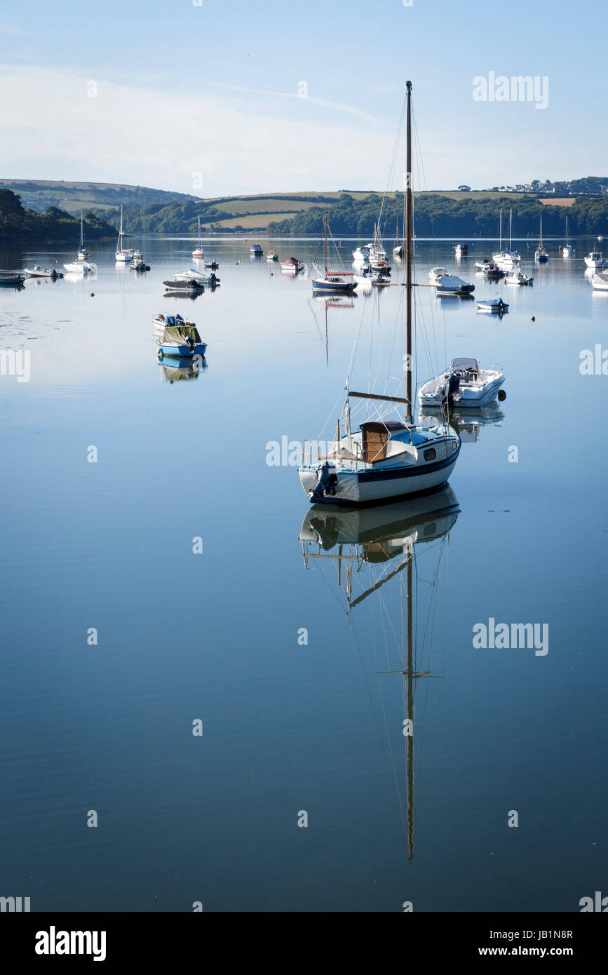 Kingsbridge Estuary in South Devon, UK. Boats reflected in calm water ...