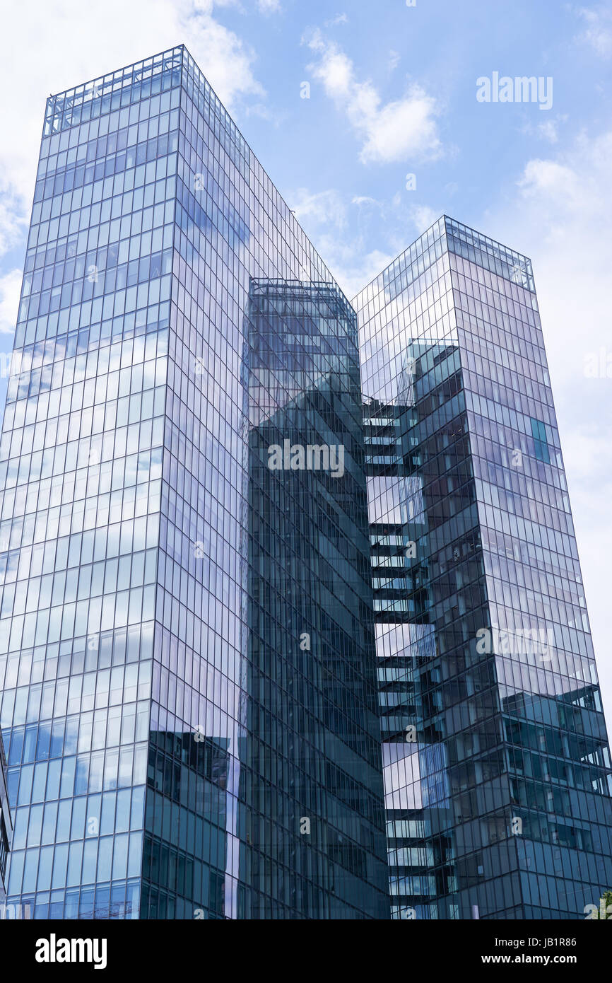 A view of modern glass buildings with clouds reflected on it Stock ...